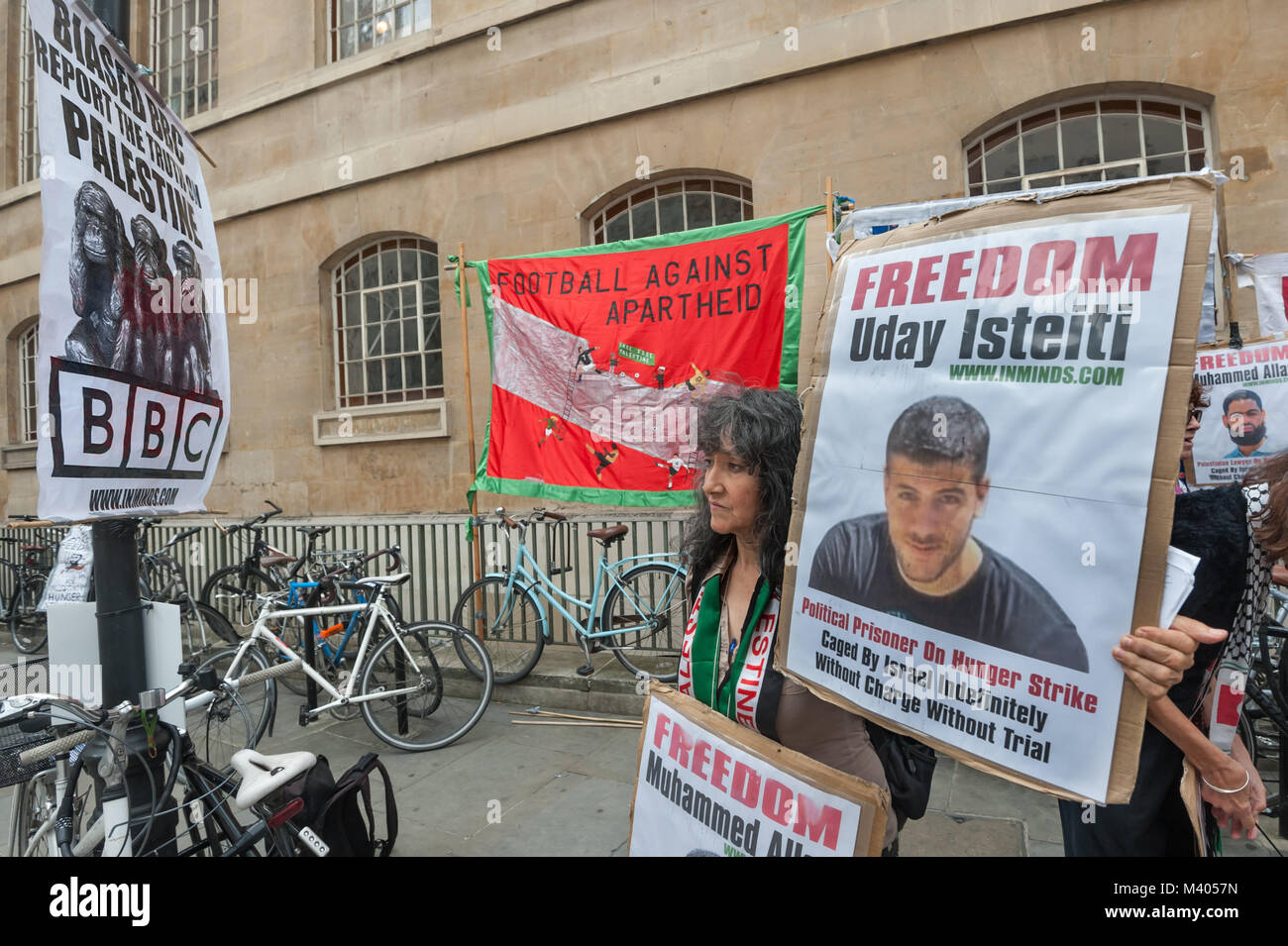 A woman holds posters about the two hunger strikes in the protest at ...