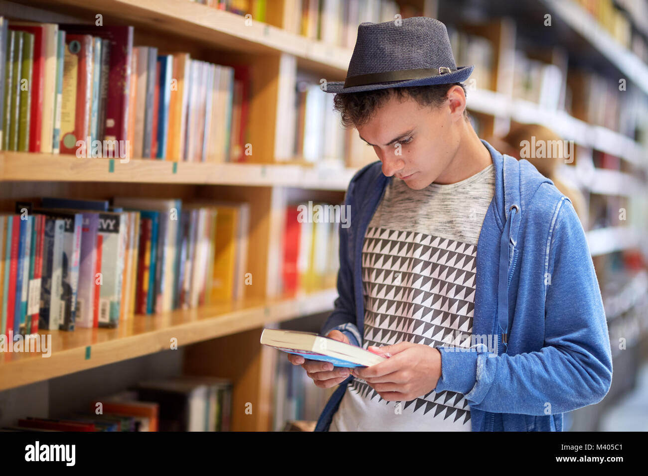 Boy choosing books library hi-res stock photography and images - Alamy