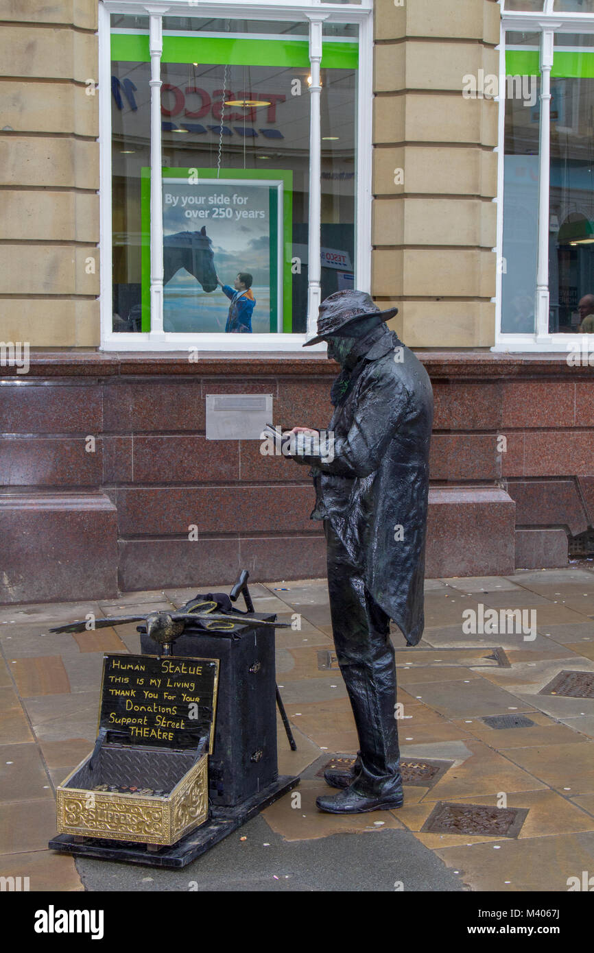 Human statue takes a break to check his mobile phone Stock Photo - Alamy