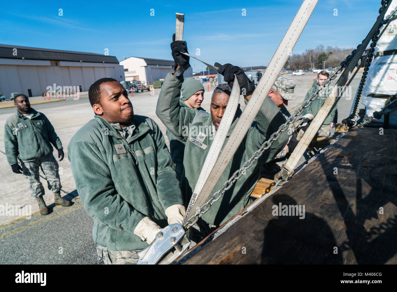 U.S. Airmen from Team JSTARS tie down equipment on a trailer for a ...