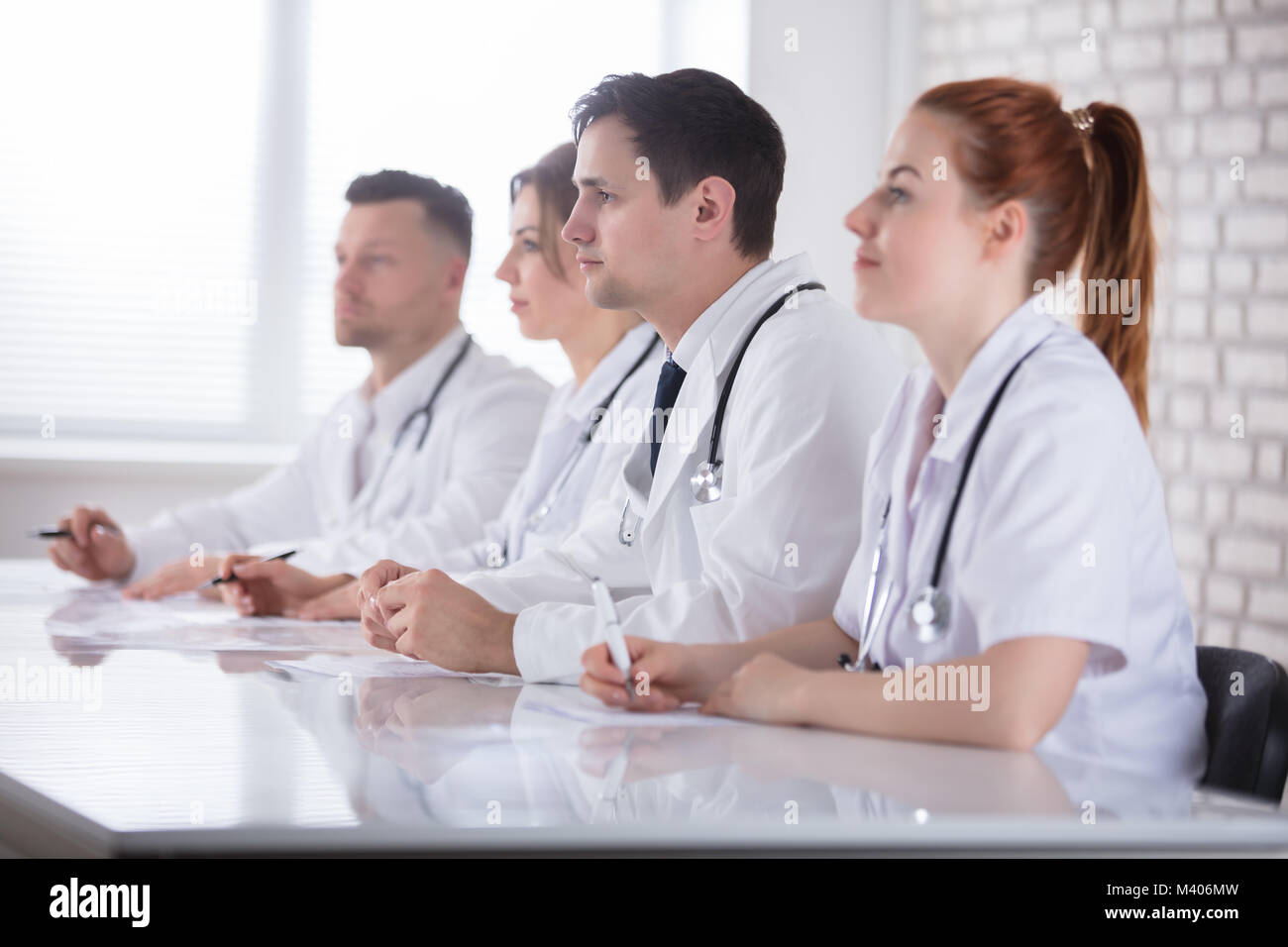 Group Of Young Professional Doctors Team In Meeting Stock Photo - Alamy