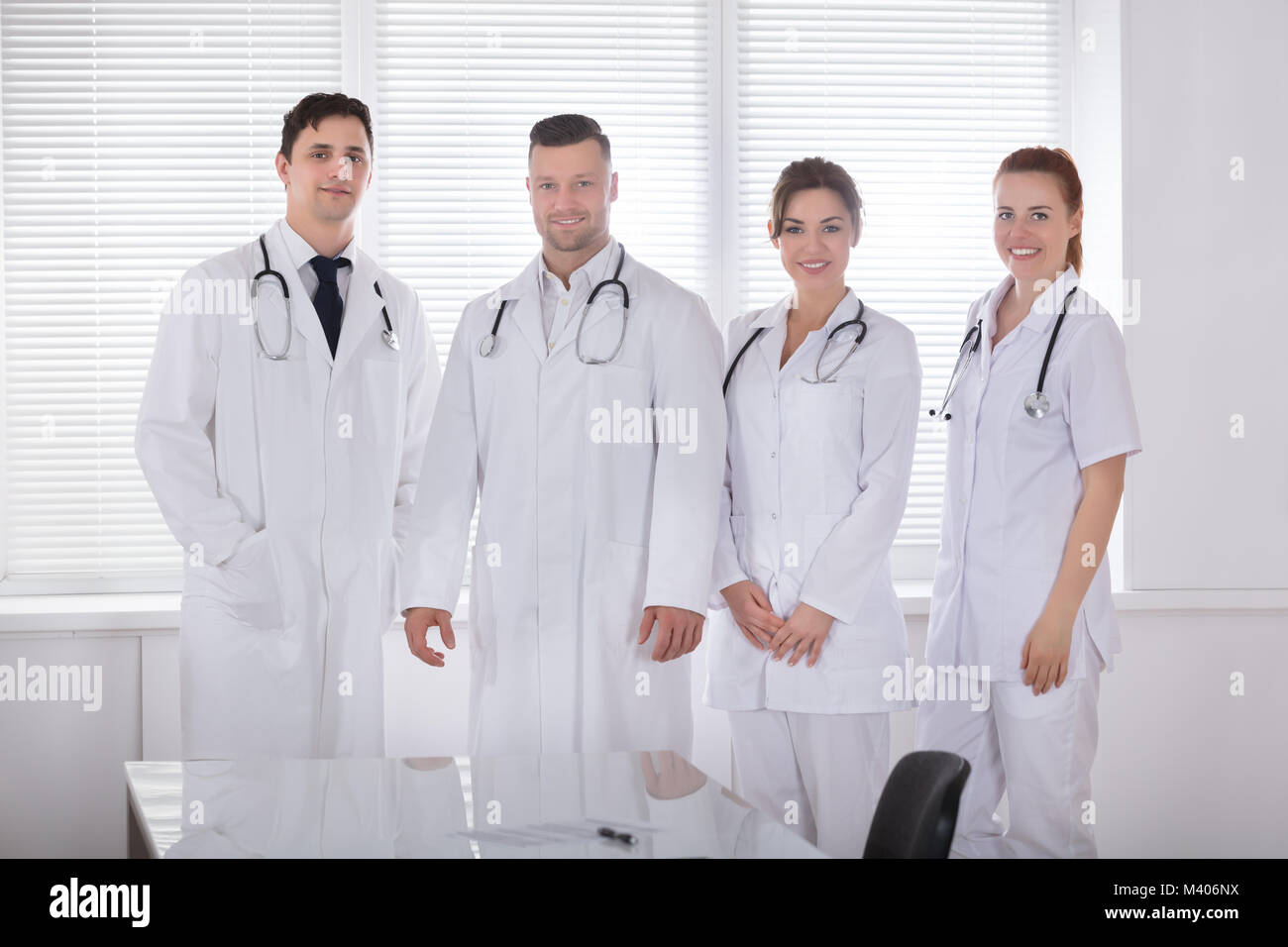 Portrait Of Smiling Professional Medical Team In Clinic Stock Photo - Alamy
