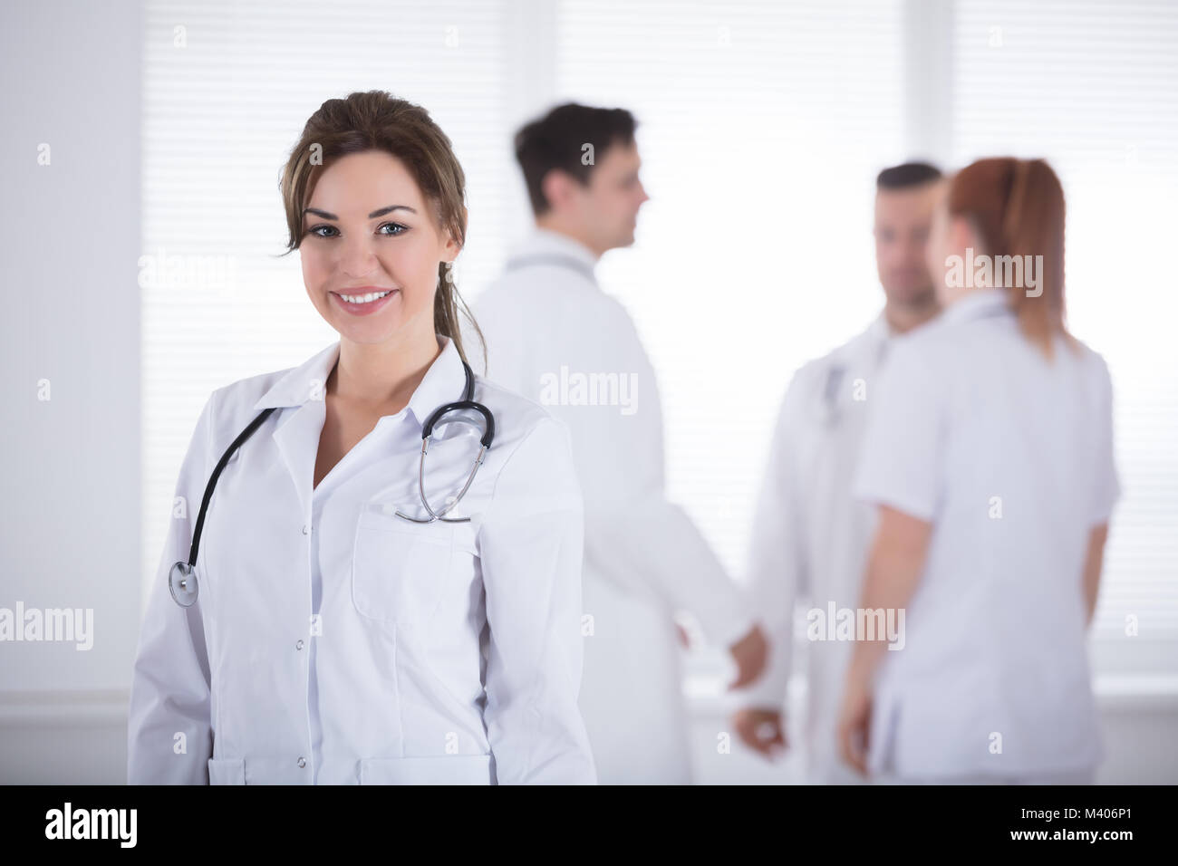 Portrait Of Young Smiling Professional Female Doctor With Stethoscope ...