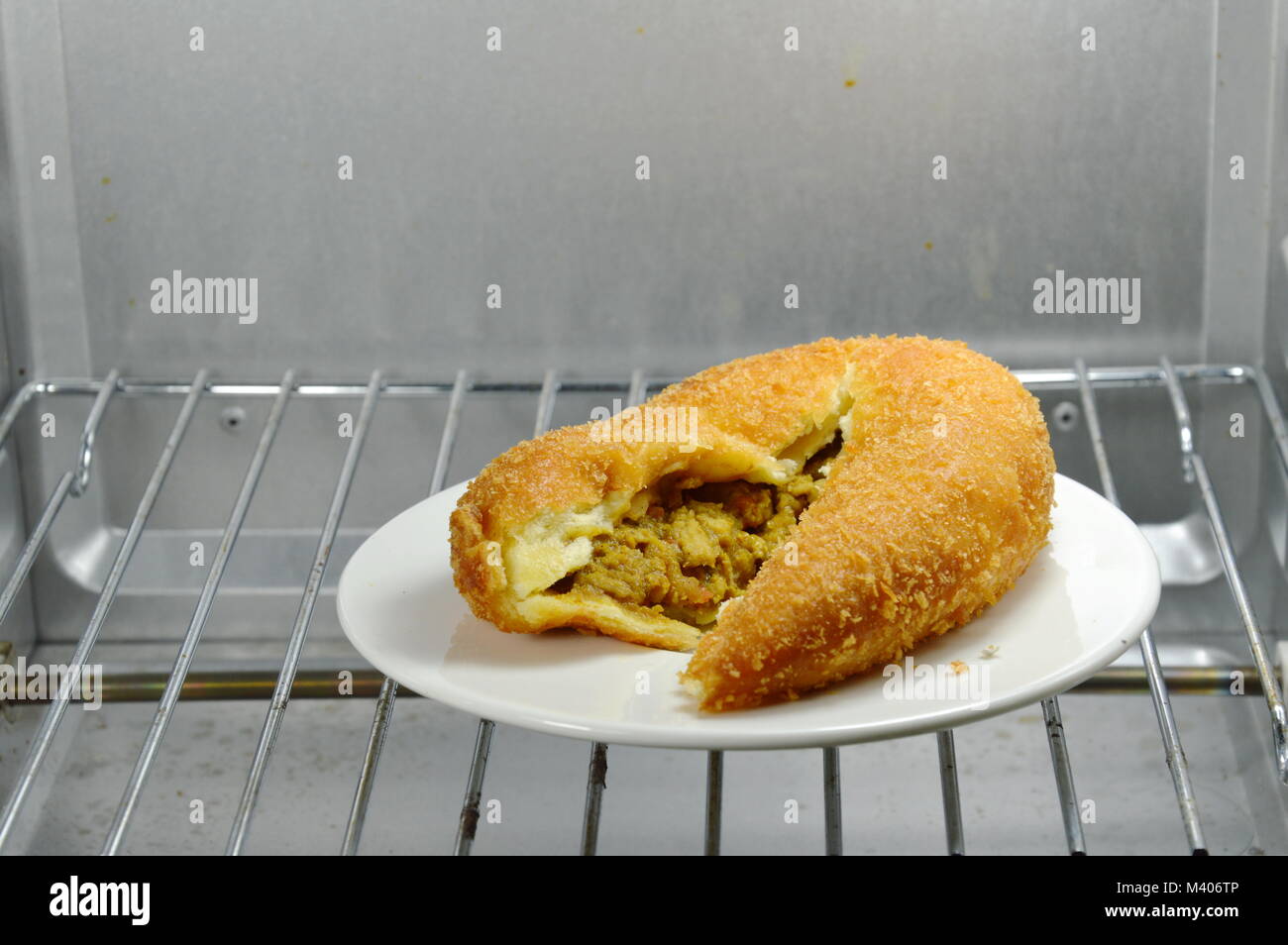 bread filling chicken curry in electric oven Stock Photo - Alamy