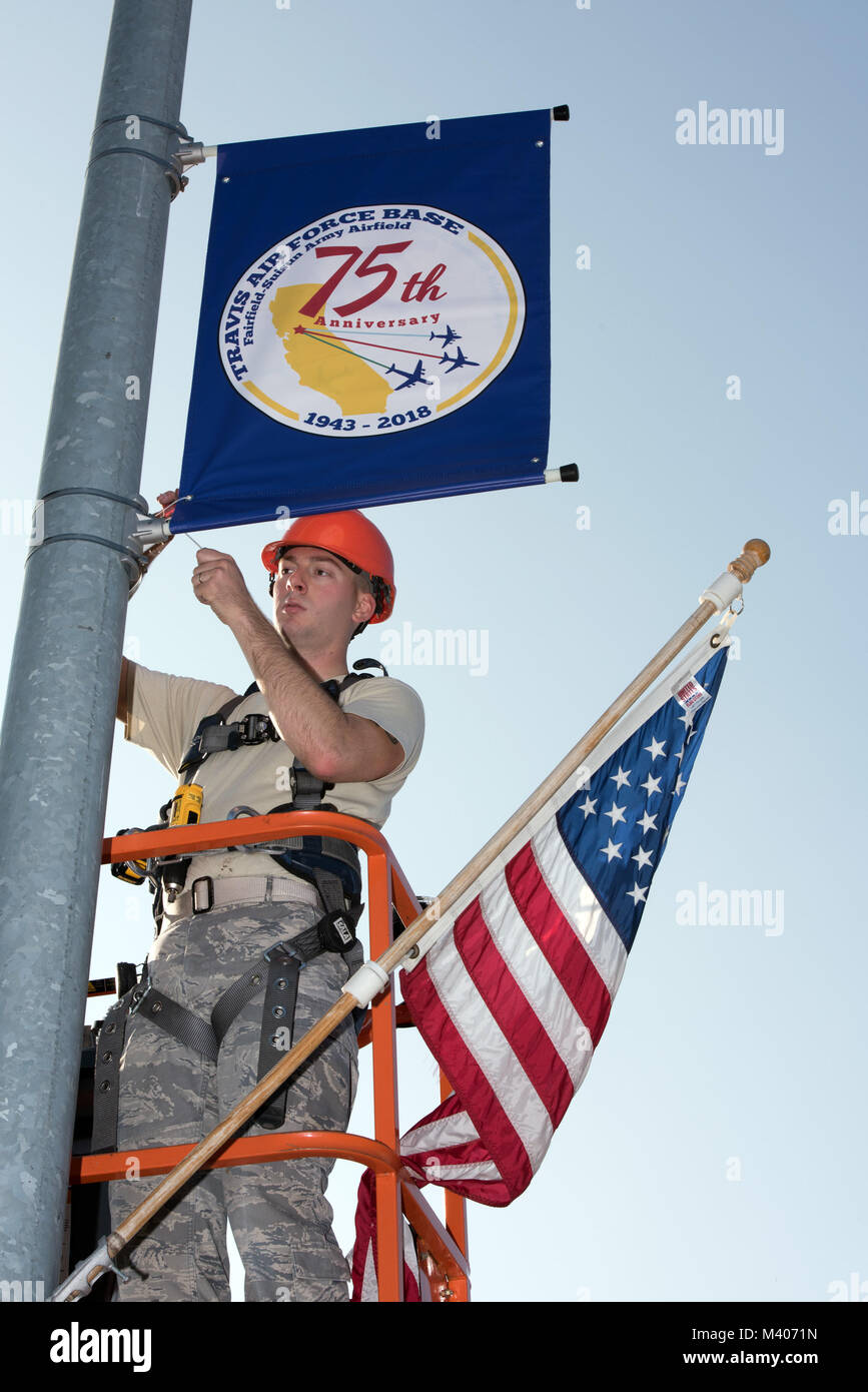 An Airman from the 60th Civil Engineer Squadron attaches the 75th ...