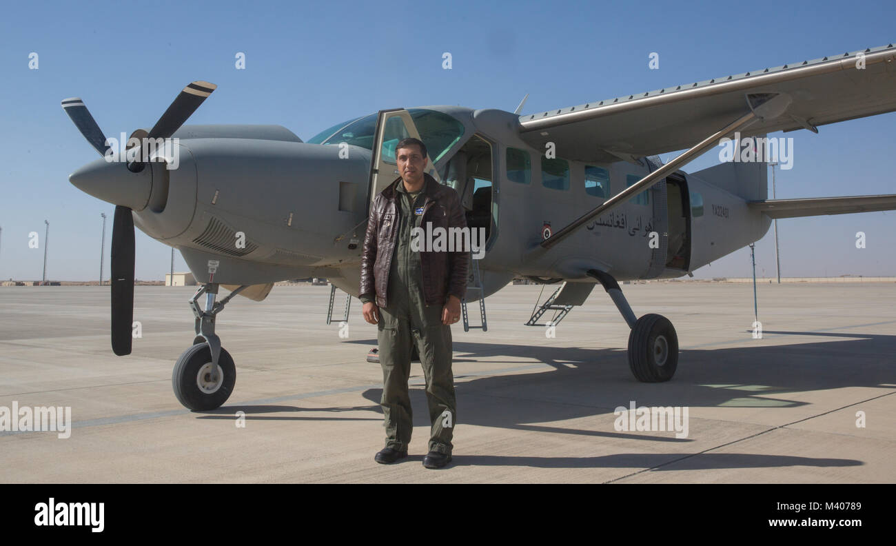 A pilot with the Afghanistan Air Force (AAF) stands in front of his ...