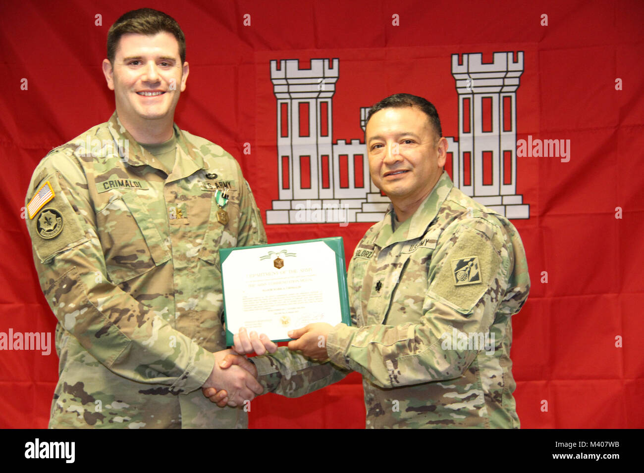 Maj. Mark Crimaldi (left) received the Army Commendation Medal from ...