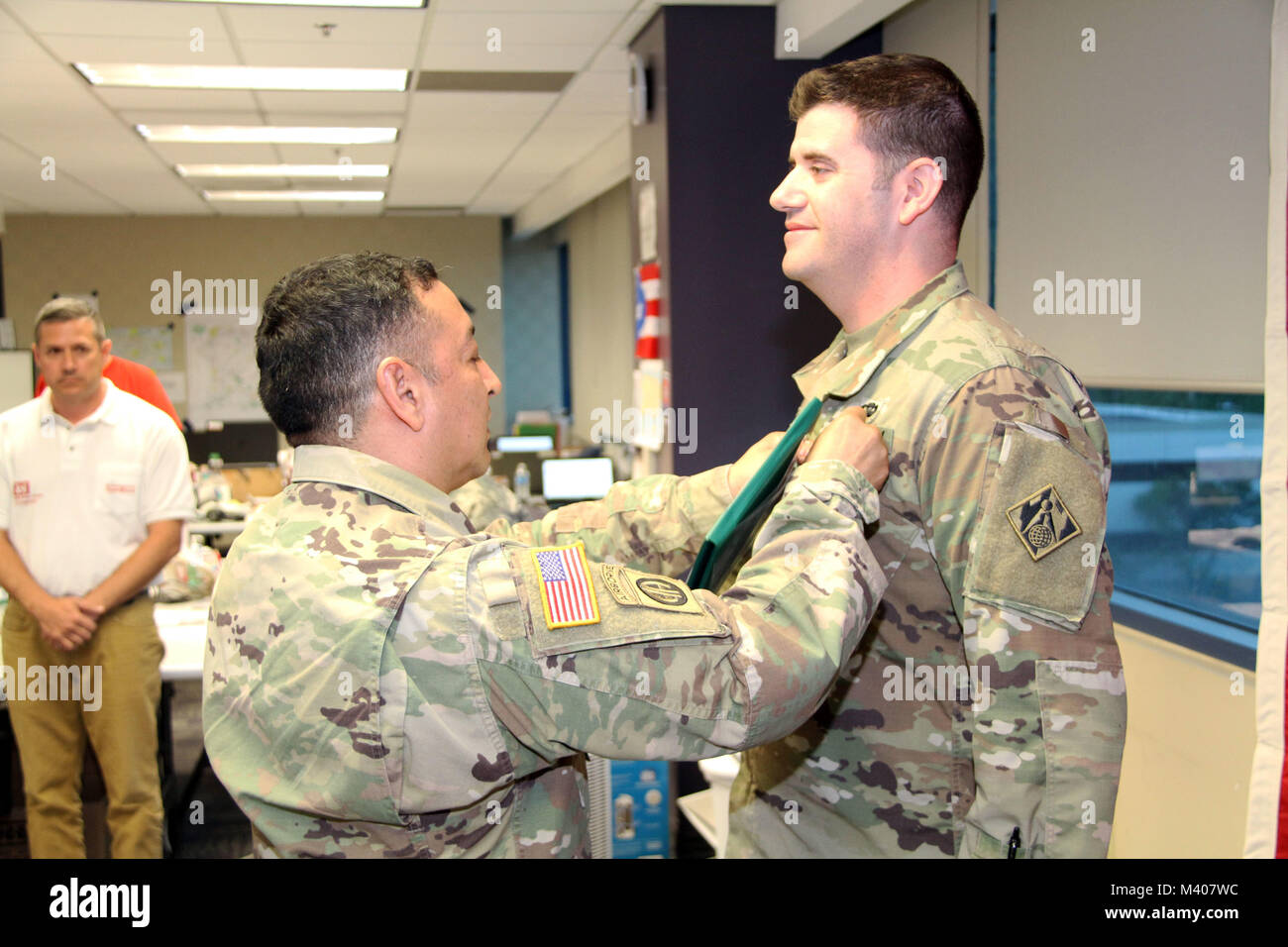 Maj. Mark Crimaldi (right) received the Army Commendation Medal from ...