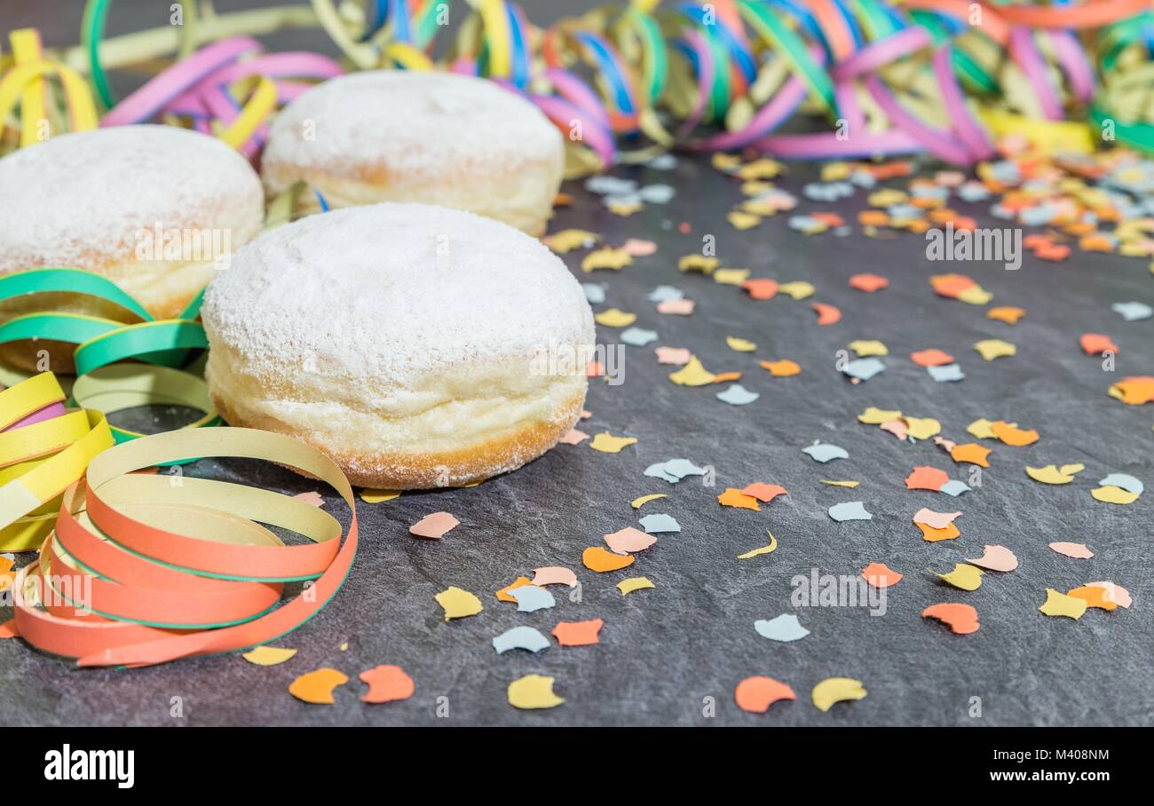Carnival Donut with carnival decoration on a slate Stock Photo - Alamy