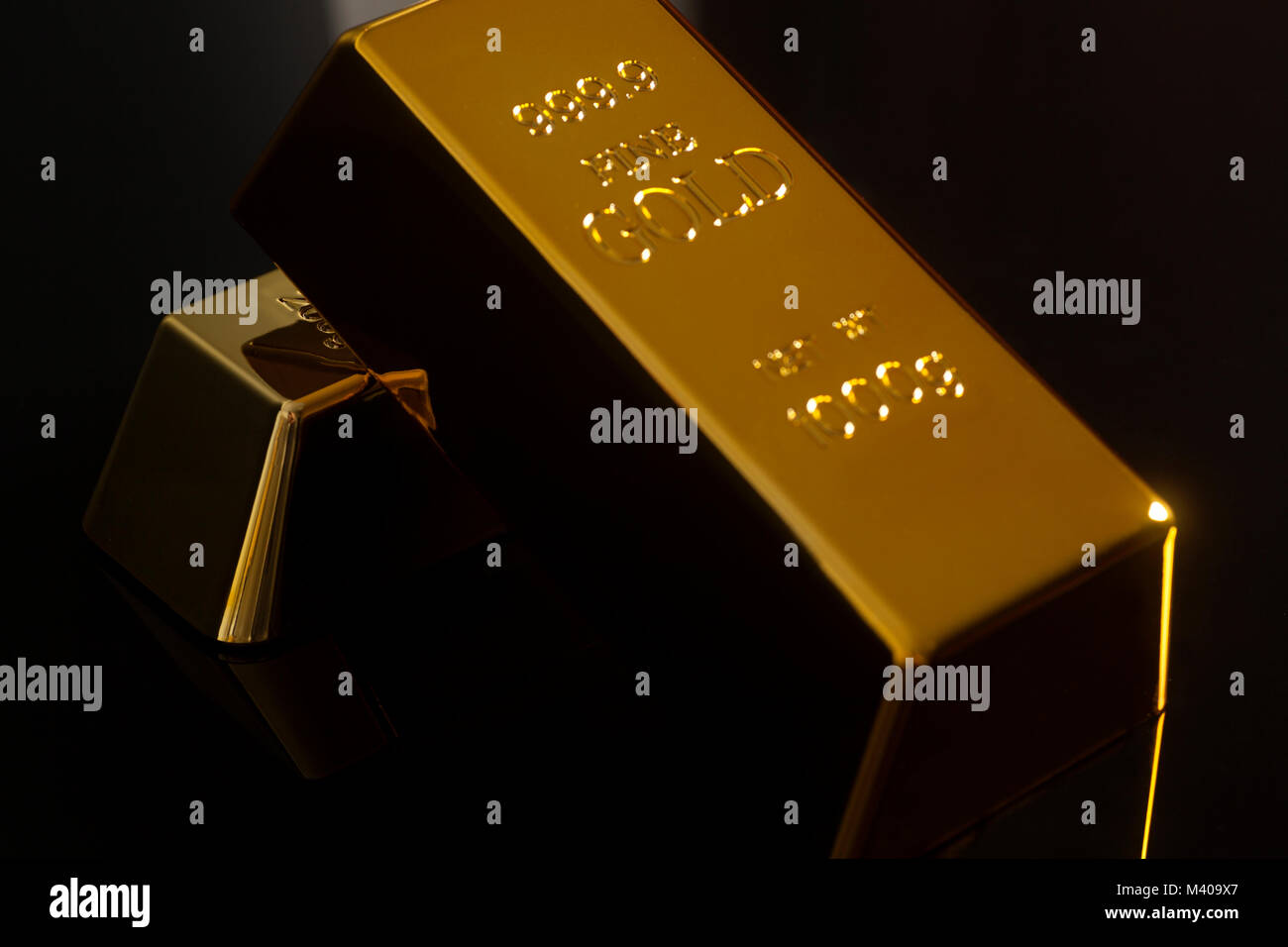 Gold bullion isolated on a black background Stock Photo - Alamy