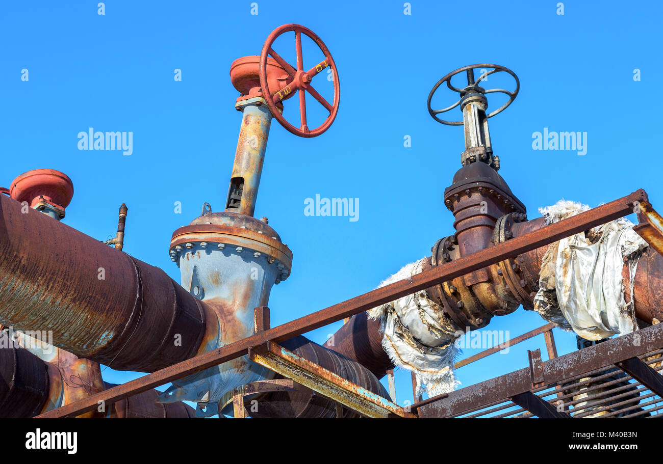 Old rusty pipeline with valves against the blue sky background Stock ...