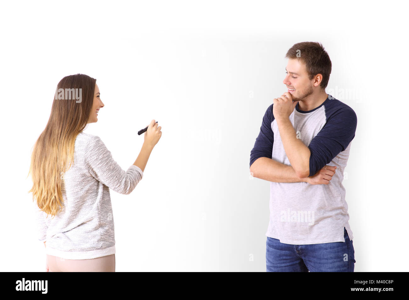 Happy couple drawing on a white wall planning future Stock Photo - Alamy