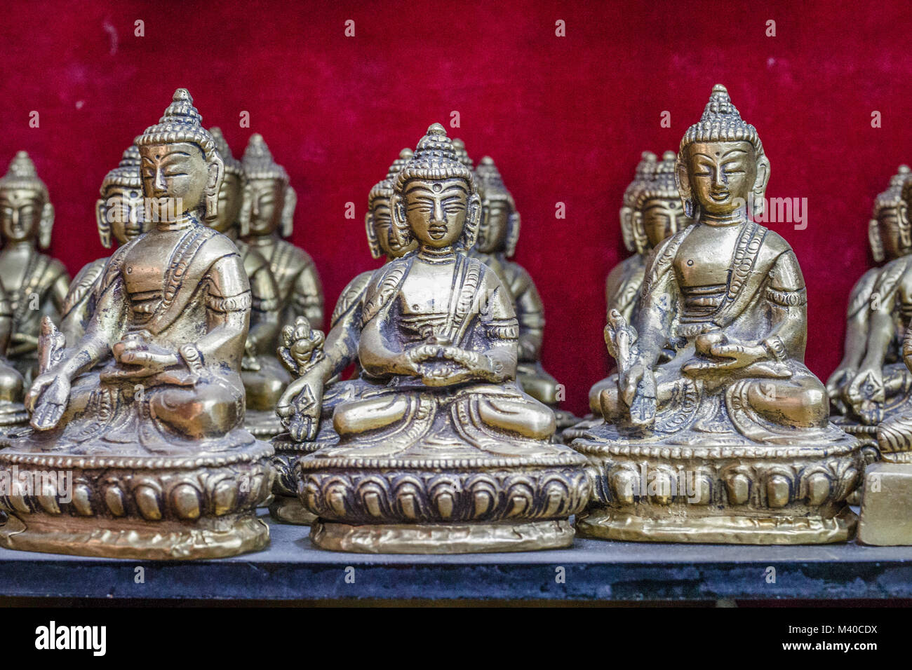 Bronze statues of Buddha sitting in a lotus flower at the souvenir ...
