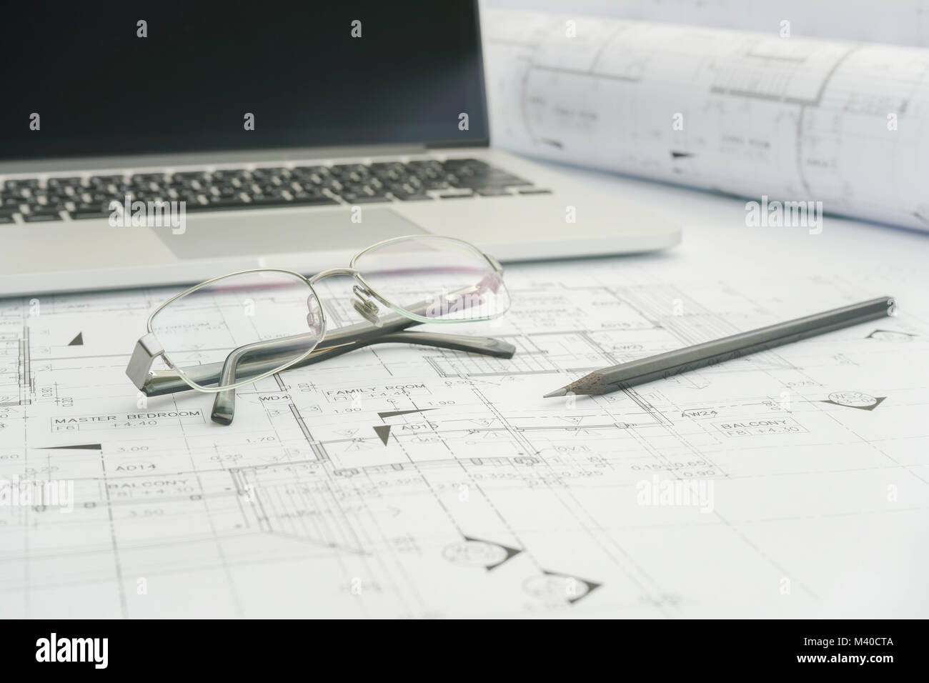 black pencil and computer laptop on architectural drawing paper for ...