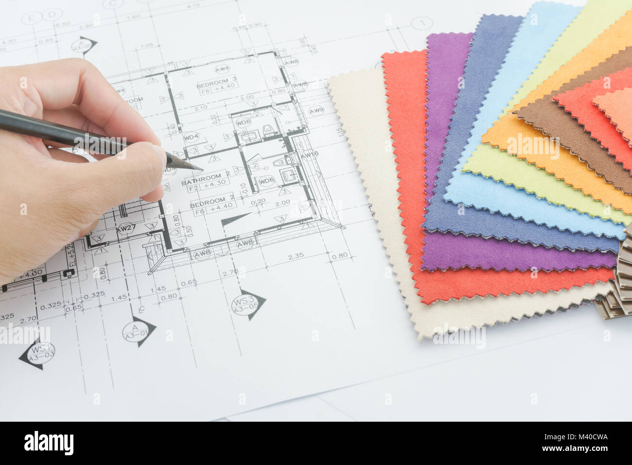 Close up hand writing on architectural drawing with fabric sample Stock ...