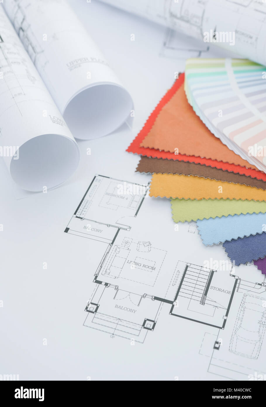 Architectural drawing with color palette , fabric sample and a roll of ...