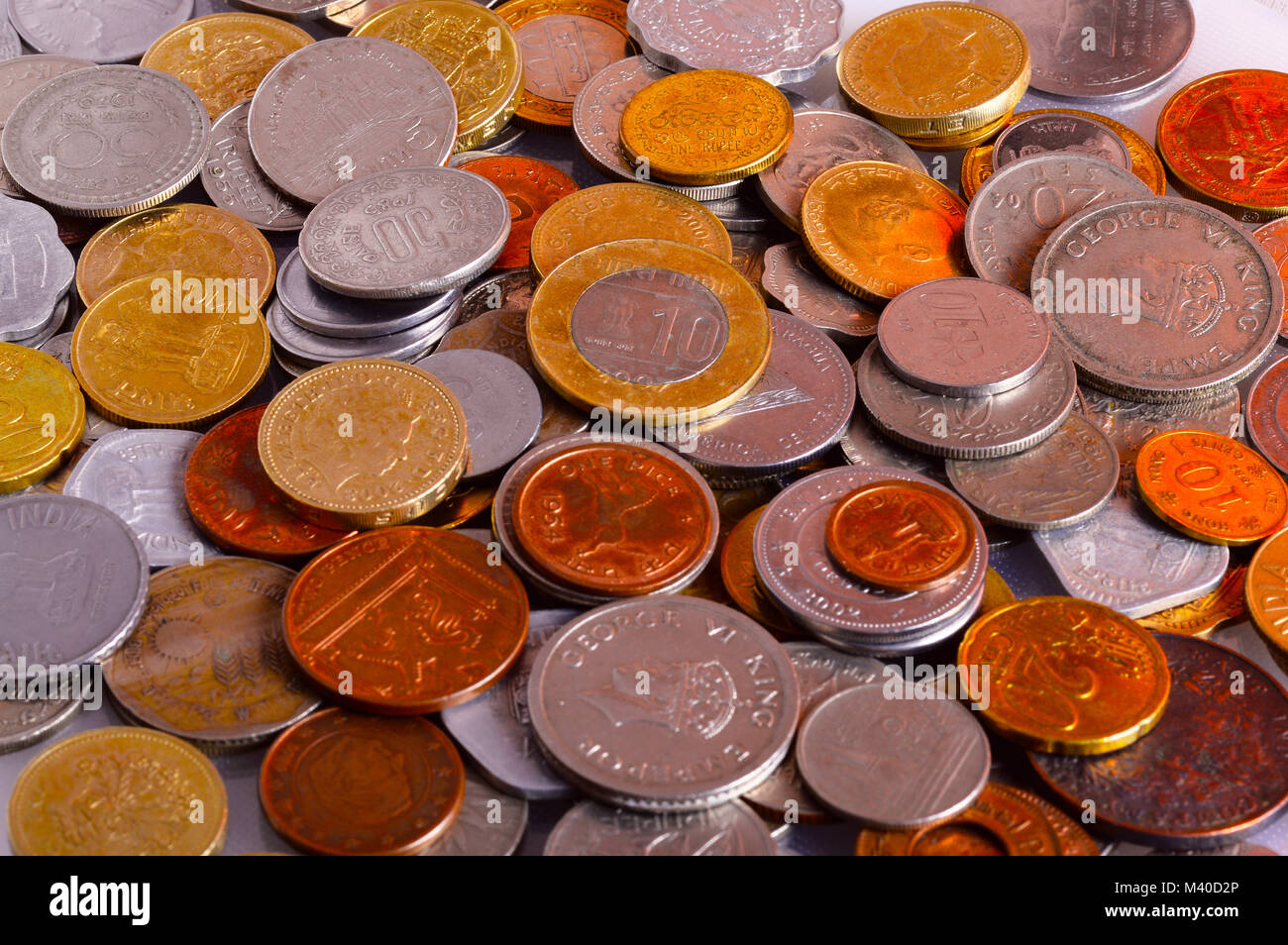 Pile of coins in different currencies Stock Photo - Alamy