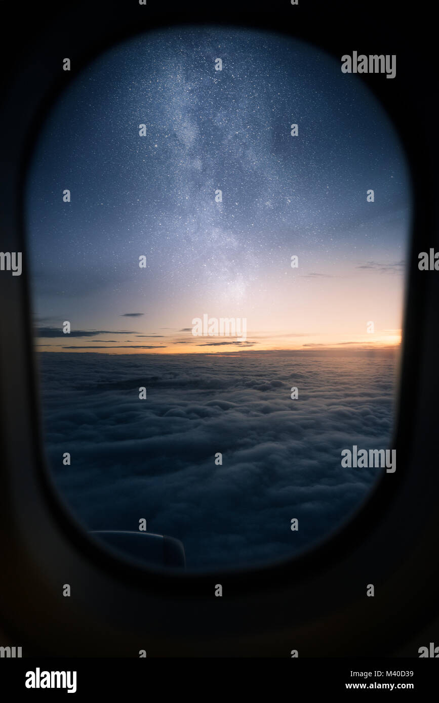 Beautiful view out of airplane window during sunrise with milky way on ...
