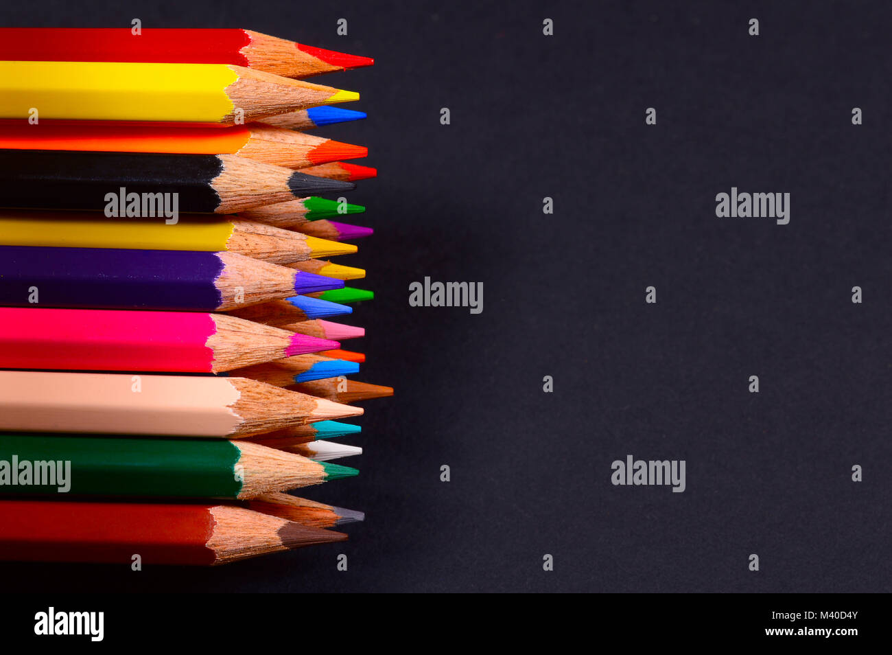 Colored pencils on black background Stock Photo - Alamy