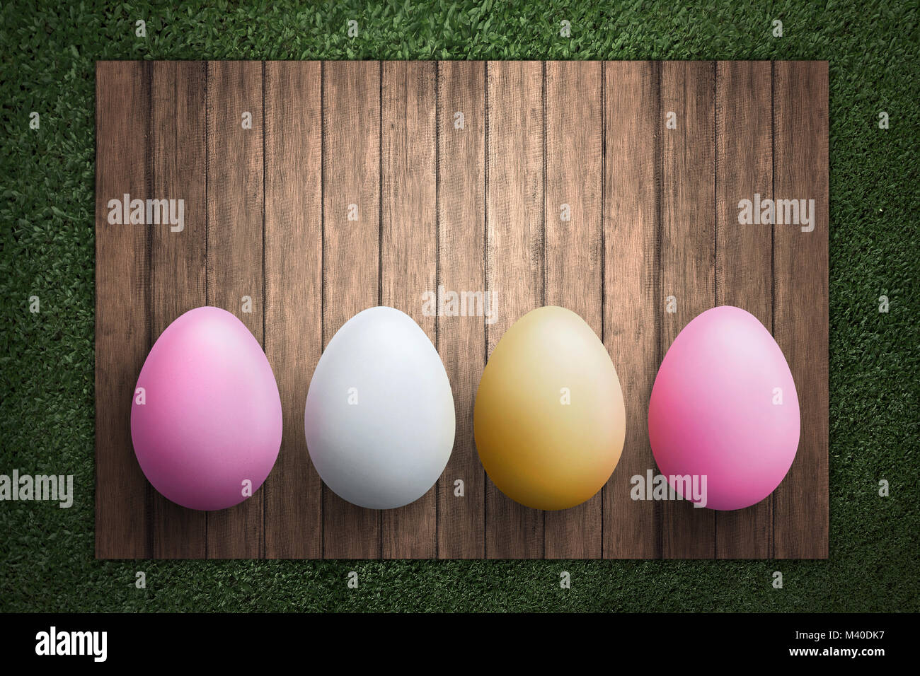 Row of Easter eggs on wooden plank with green grass background Stock ...