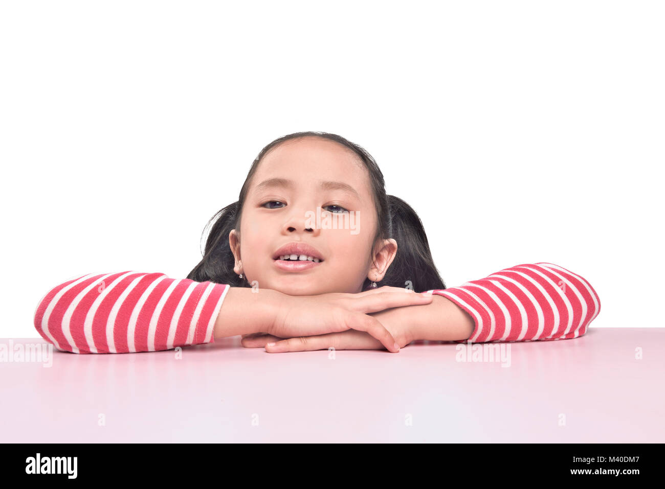 Portrait of asian little girl lean on the table posing isolated over ...