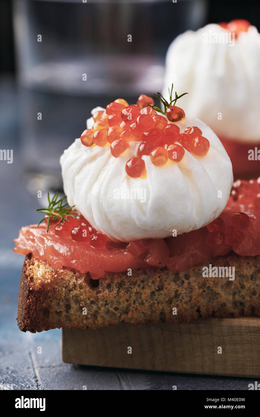Useful breakfast with poached egg, caviar and red fish Stock Photo - Alamy