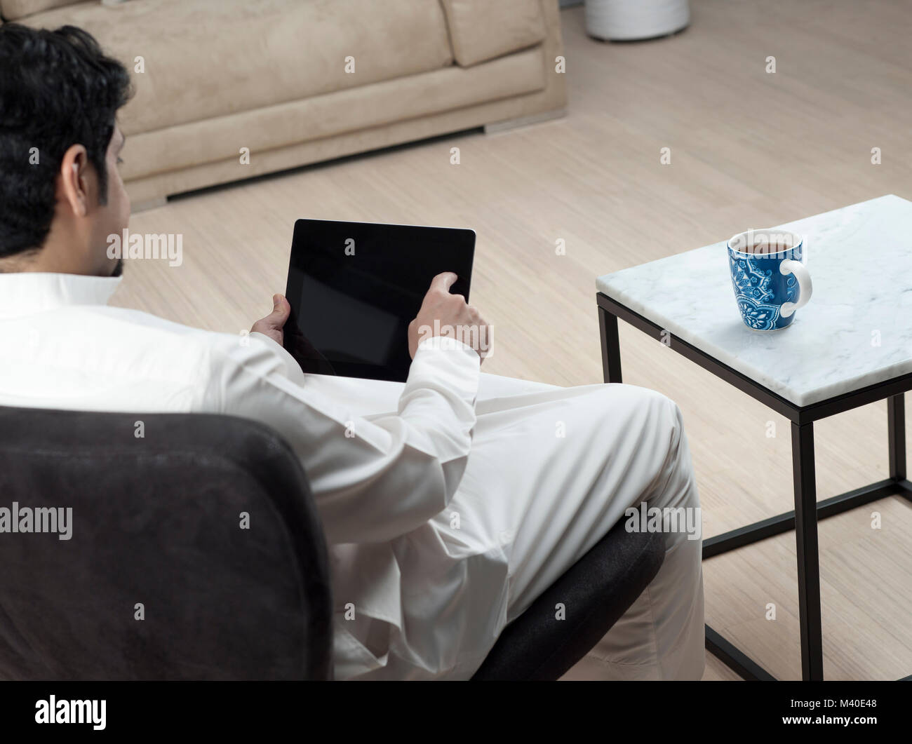 Saudi Arabian Man Using Tablet at Home Environment Stock Photo - Alamy