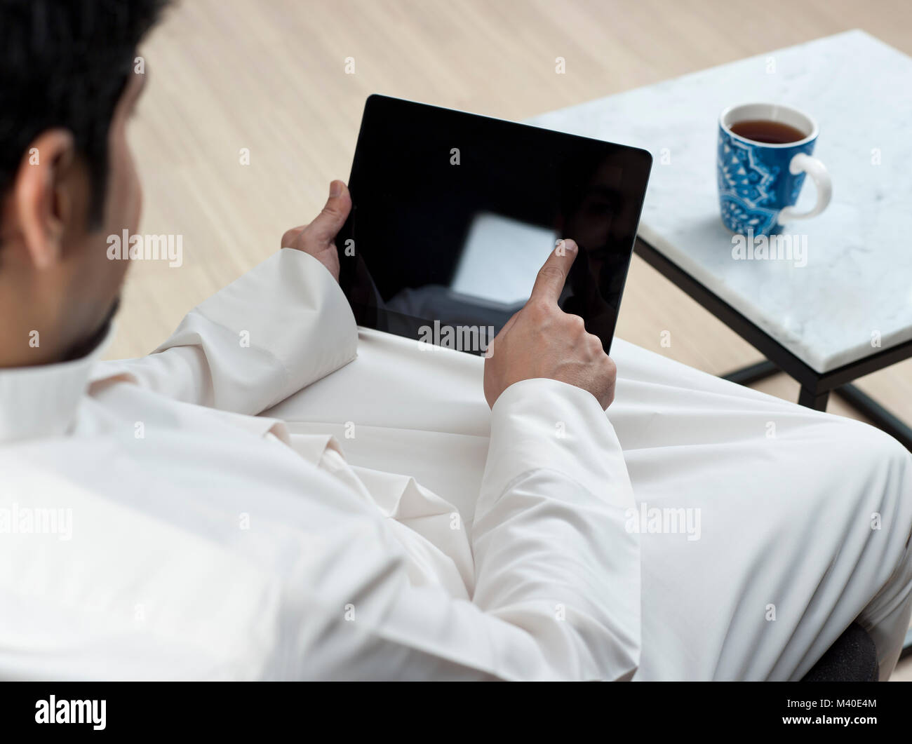 Saudi Arabian Man Using Tablet at Home Environment Stock Photo - Alamy