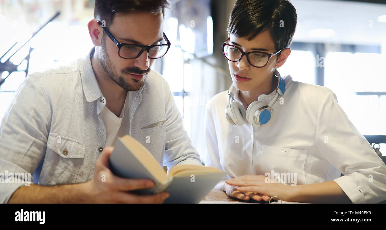 Happy couple studying in library Stock Photo - Alamy