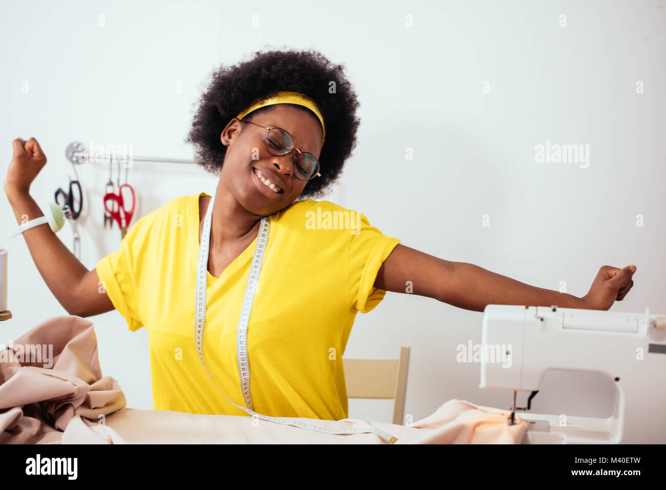young tailor woman dancing with mannequin in tailoring workshop Stock ...