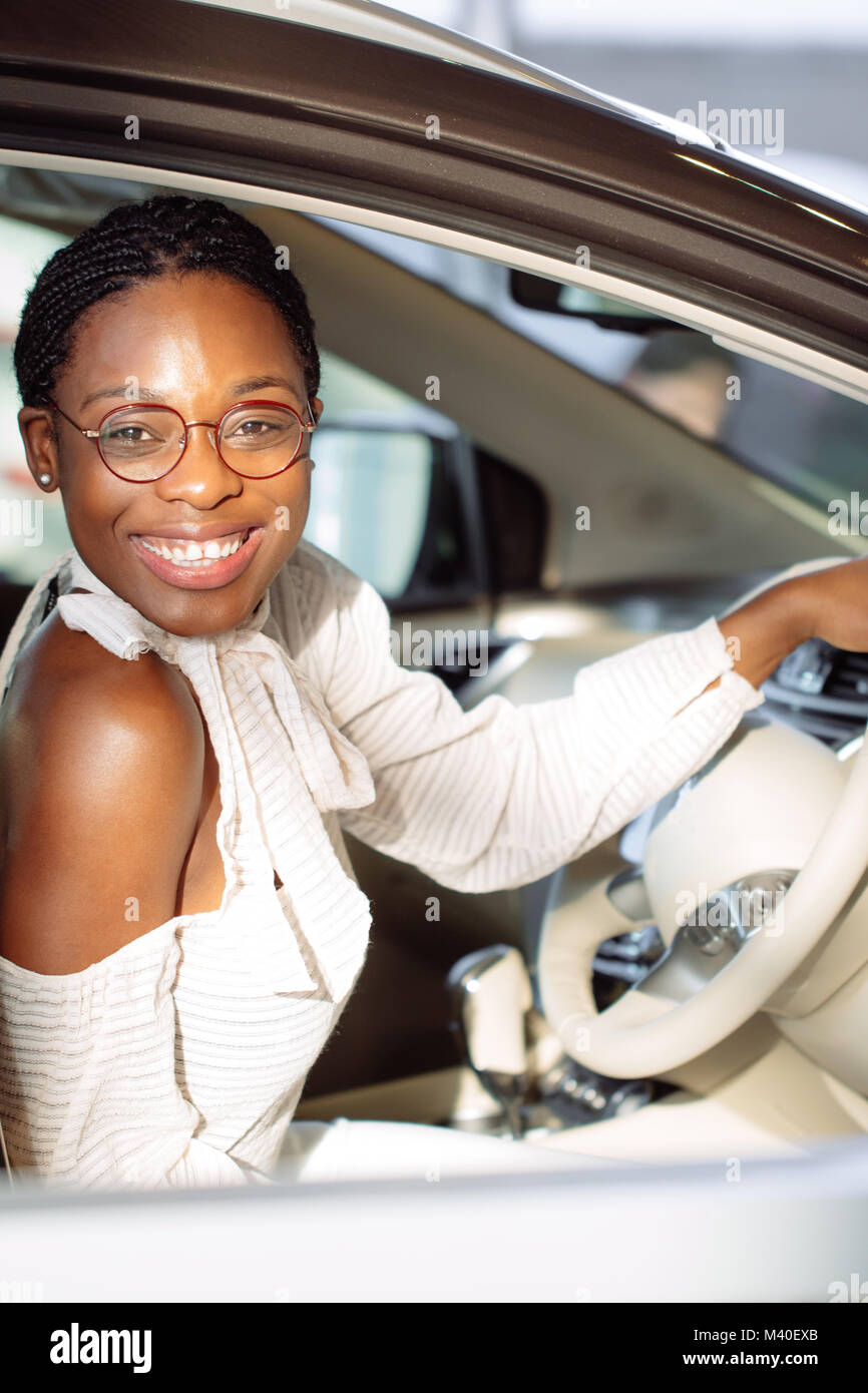 cheerful african female driver inside car Stock Photo - Alamy