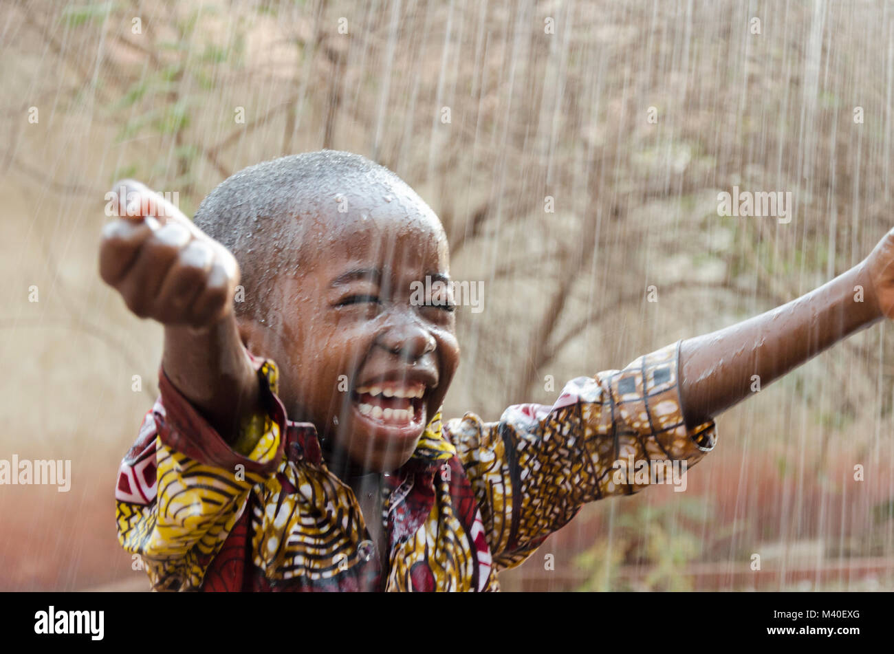 Little Native African Boy Standing Outdoors Under the Rain (Water for ...