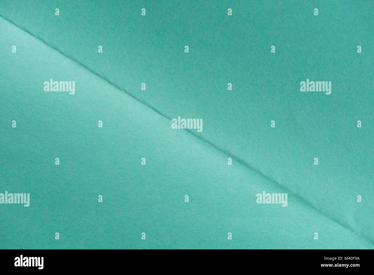 close-up shot of turquoise color folded paper for background Stock ...