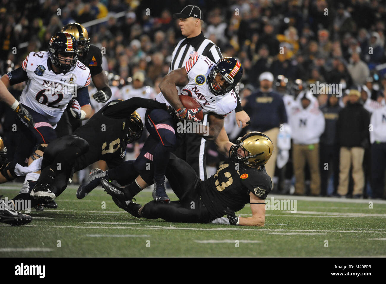 Navy fullback Chris Swain breaks through Army defenders during the ...