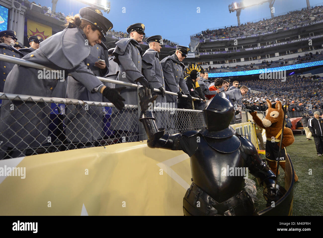 The U.S. Military Academy Black Knight and Mule mascots high five their ...