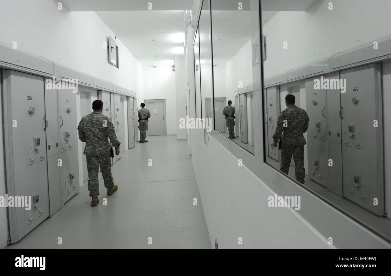 U.S. Army Staff Sergeant Michael Pine (left), a Corrections Specialist ...