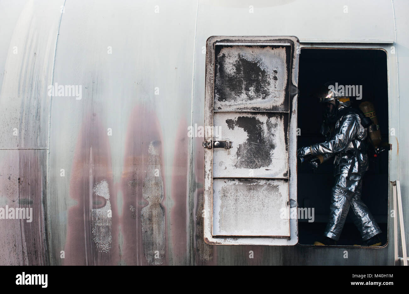 A U.S. Air Force firefighter moves through a mock aircraft during a ...