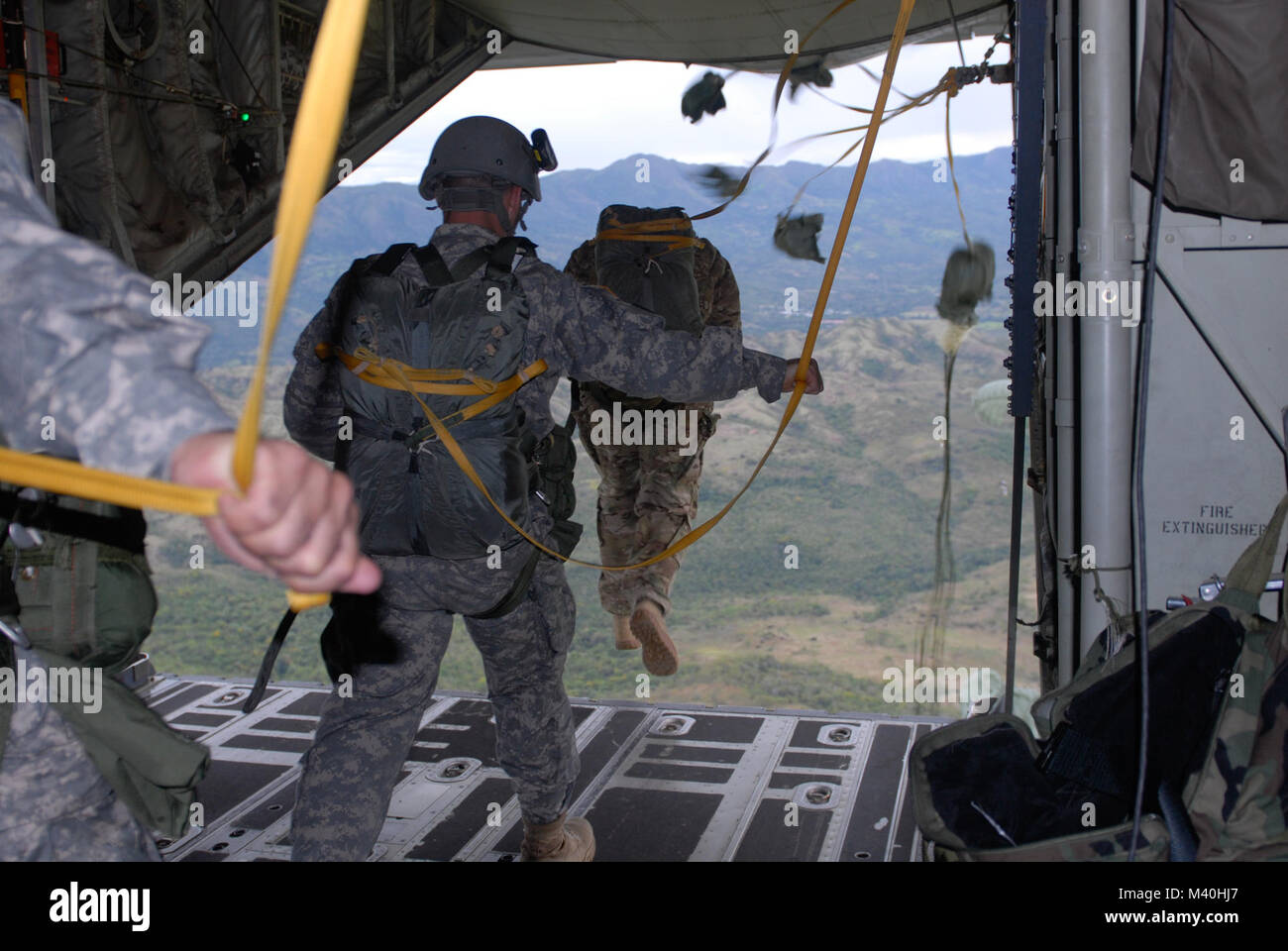 Competitors conduct a static line jump from a C-130 aircraft during ...