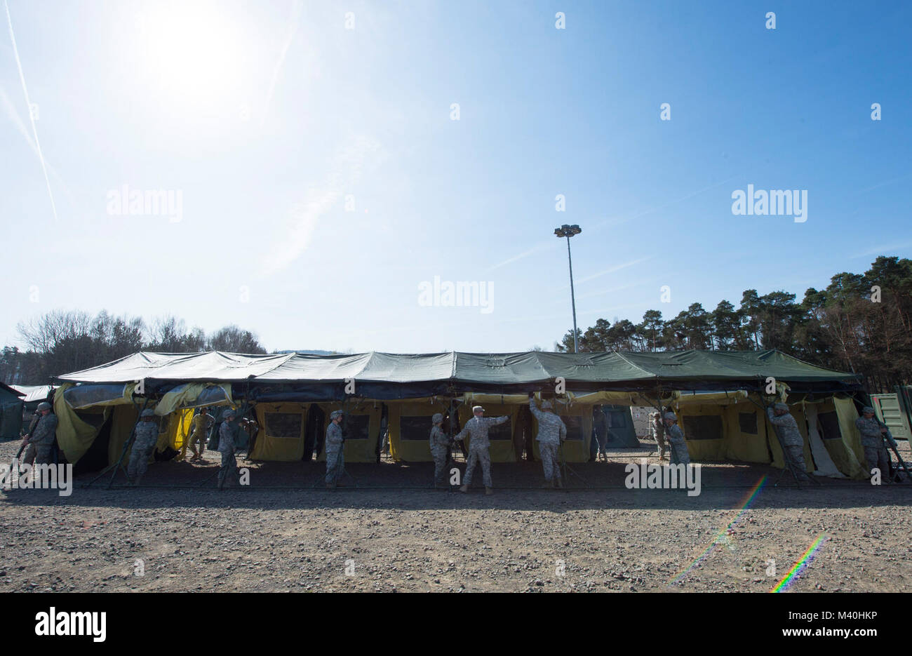 Members of the 212th Combat Support Hospital (CSH) build a fully ...