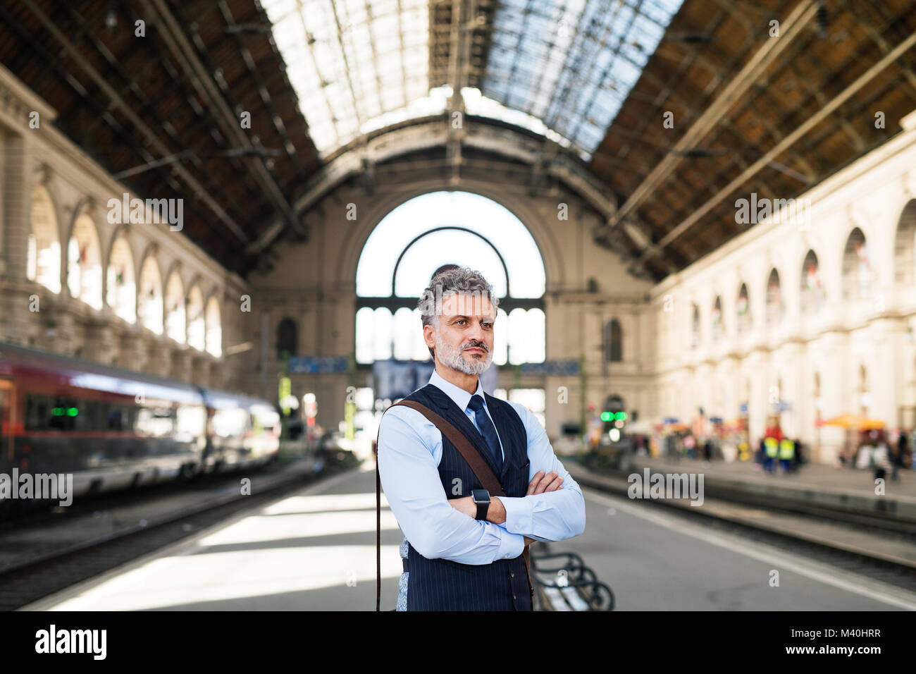 Man standing train station bench hi-res stock photography and images ...