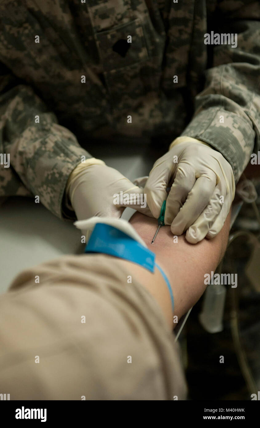 Blood is drawn from a patient during a field medical training exercise ...