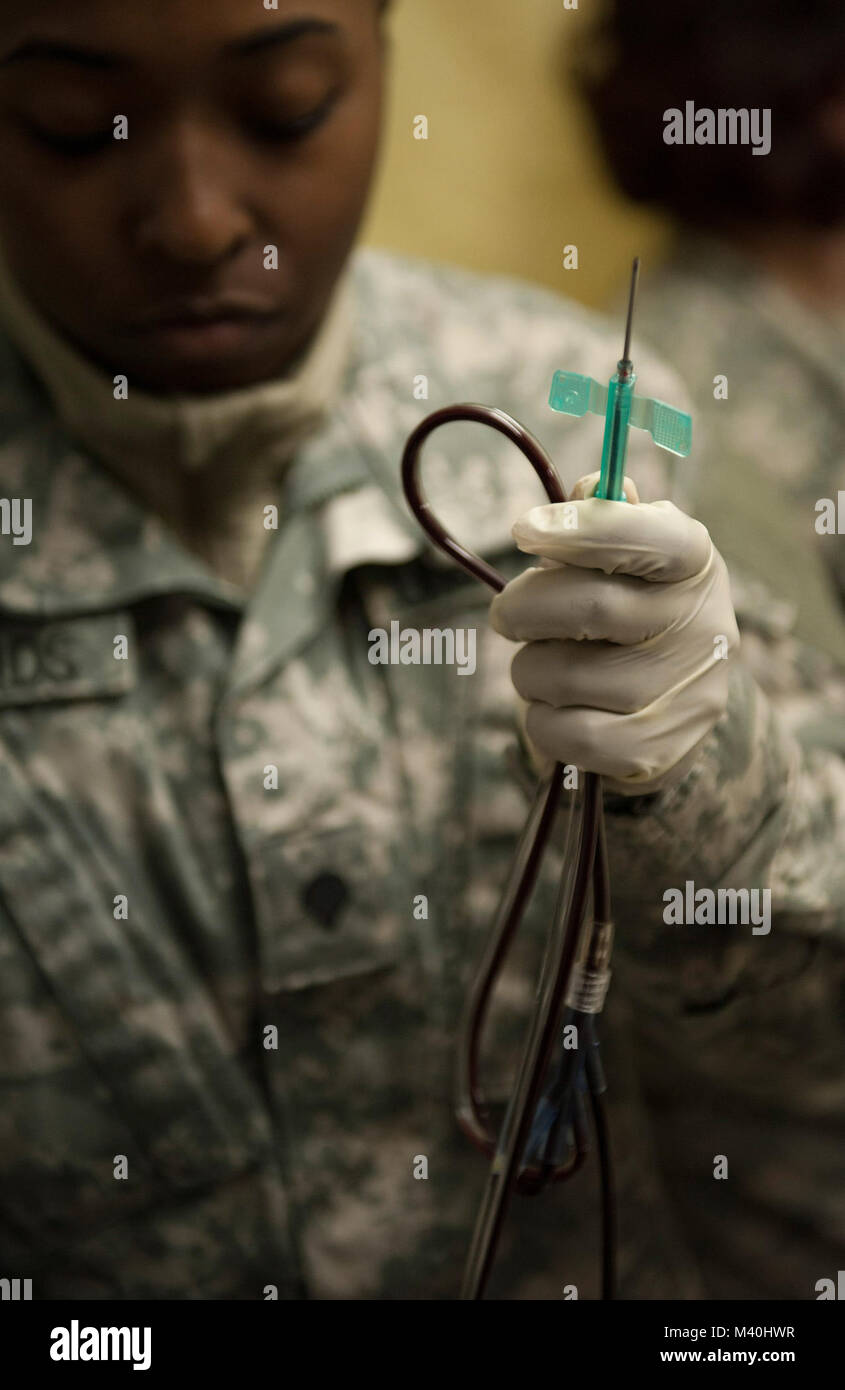 Blood is drawn from a patient during a field medical training exercise ...