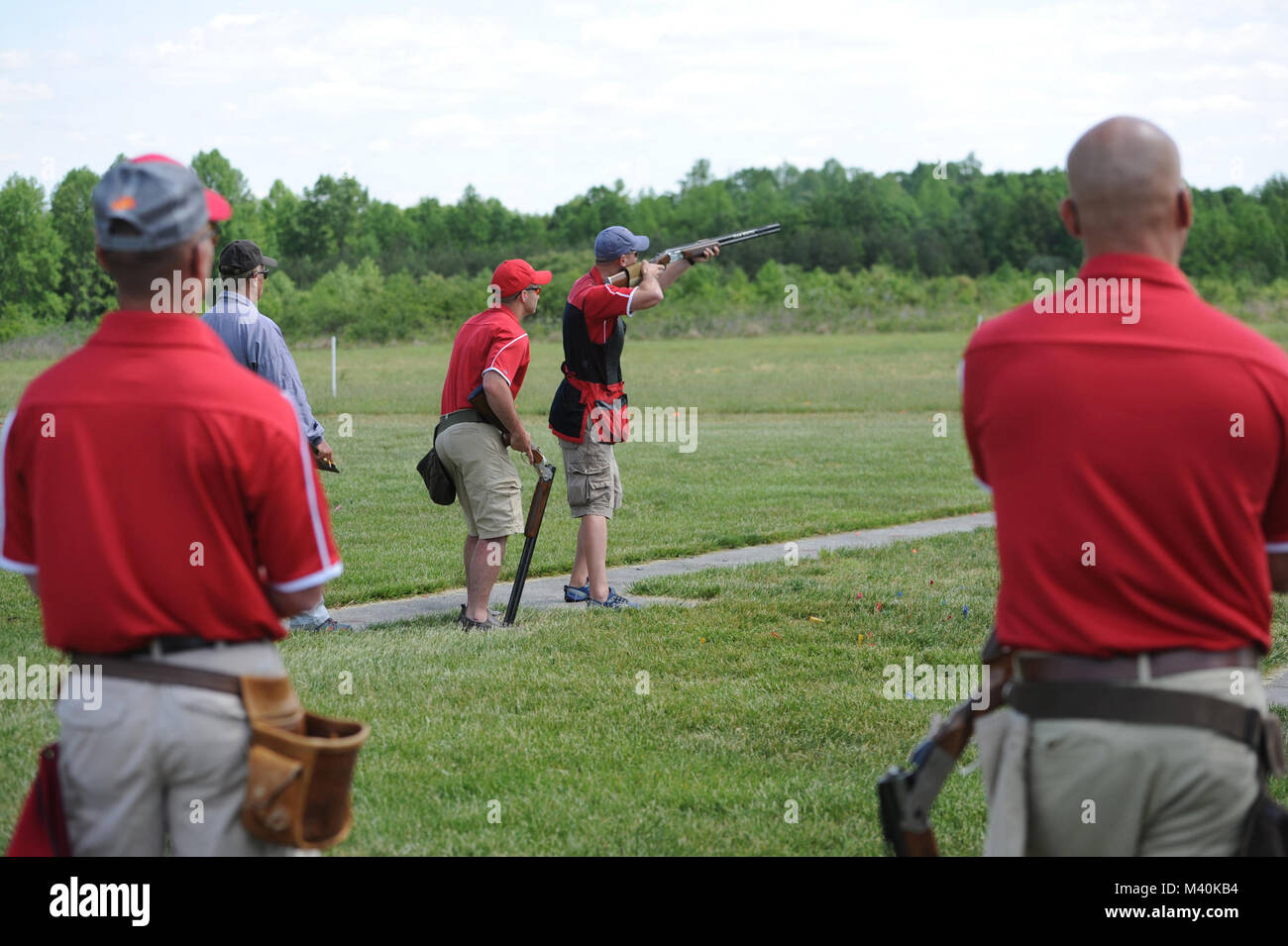 1st Lt. Patrick Fedak shoots as members of the USMC Skeet Team look on ...