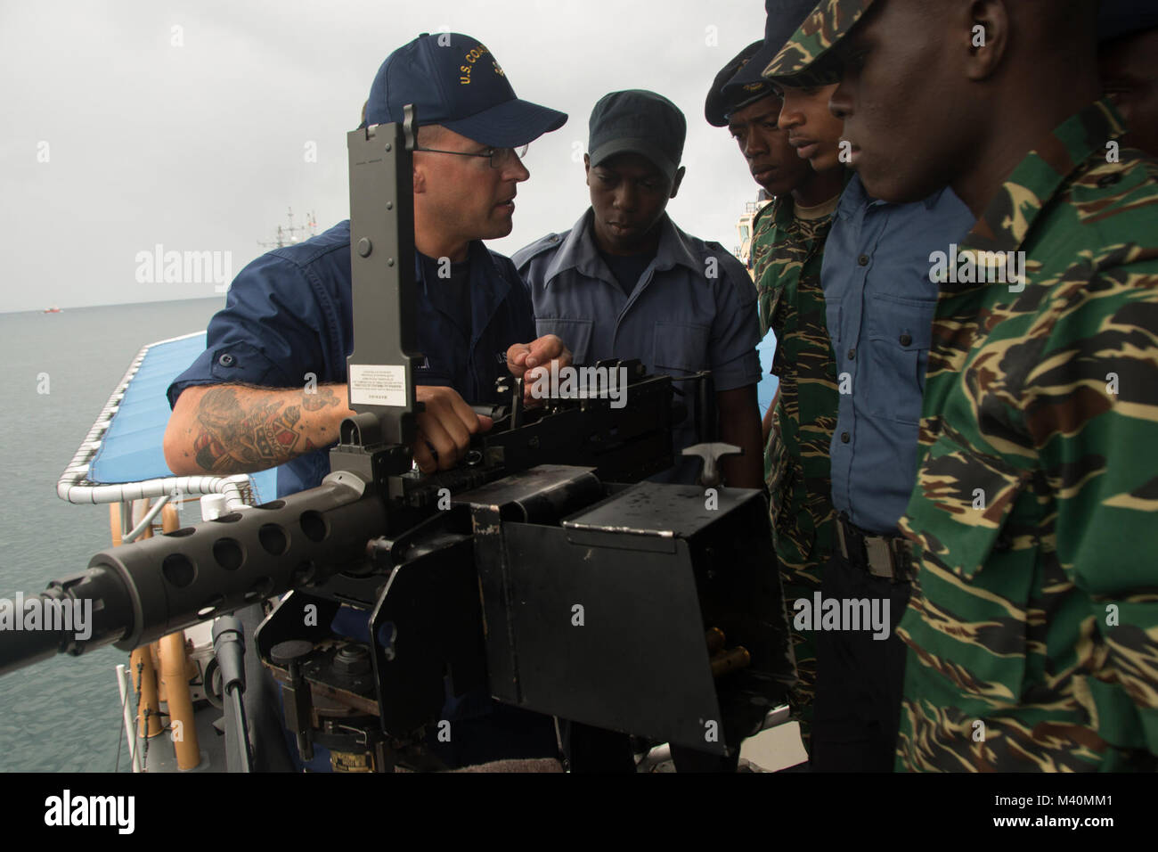 U.S. Coast Guard Petty Officer 2nd Class Matthew Masten, a gunner's ...