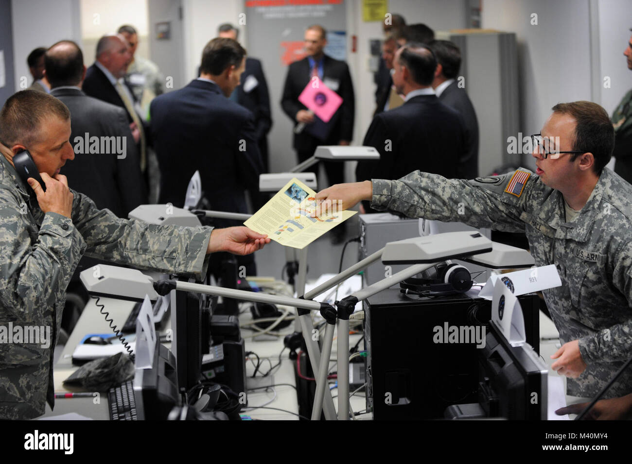 Participants brief each other and strategize during an exercise “Cyber ...
