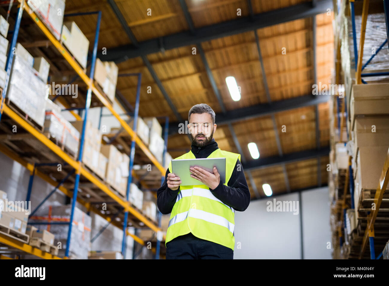 Male warehouse worker with tablet Stock Photo - Alamy