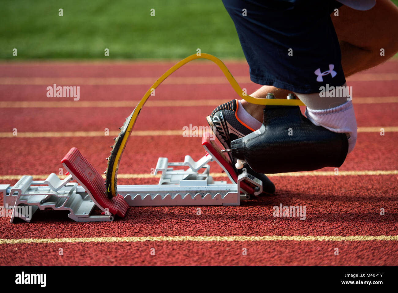An athlete begins from the starting blocks for a 400 meter dash during ...