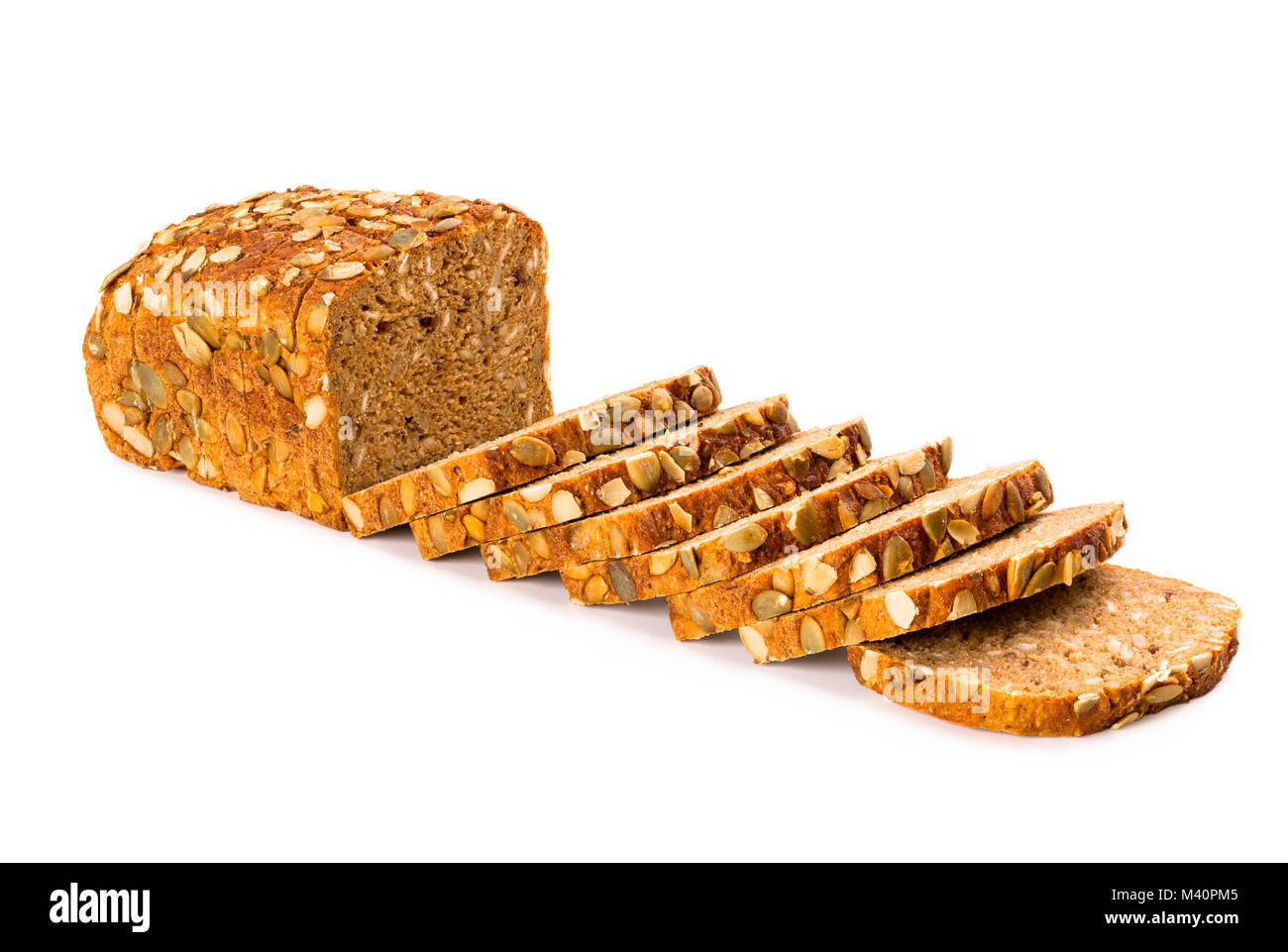 Wholemeal granary bread partly sliced isolated on white background ...
