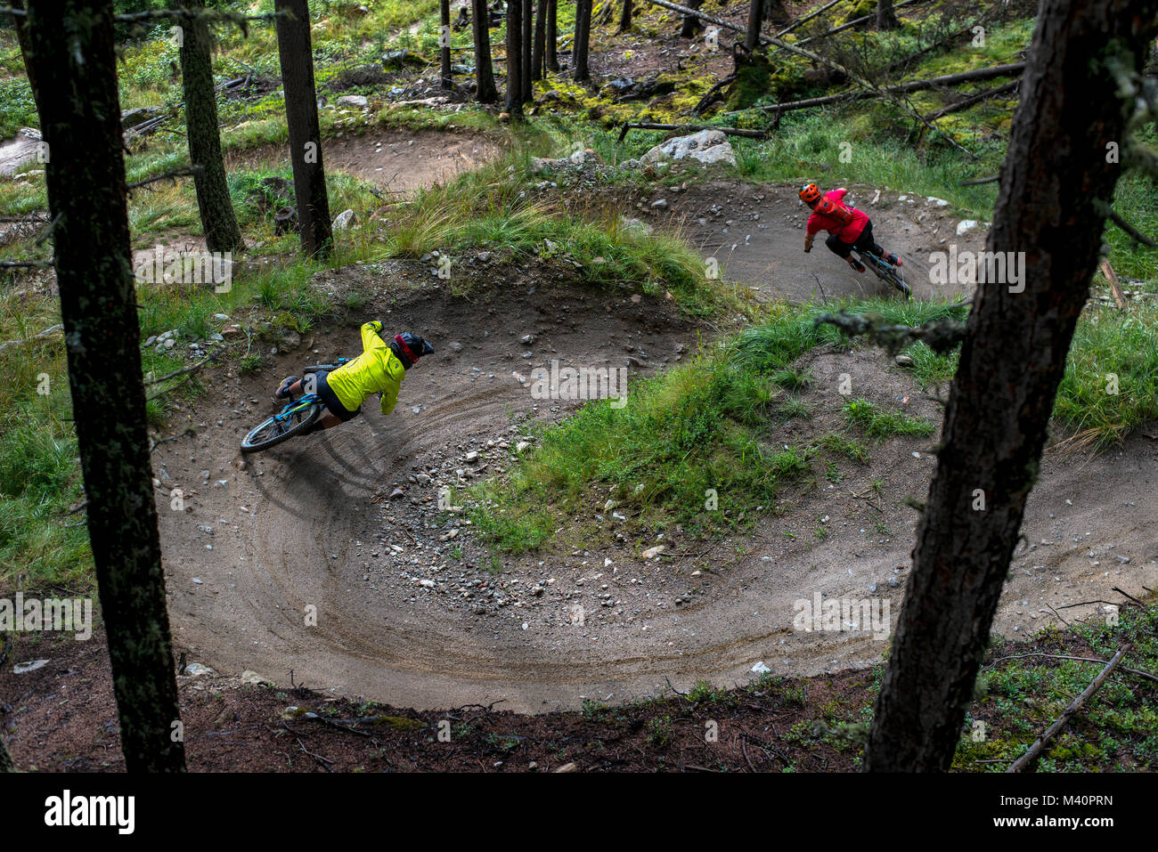 Two mountain bikers ride a trail in the Austrian alpine resort of ...