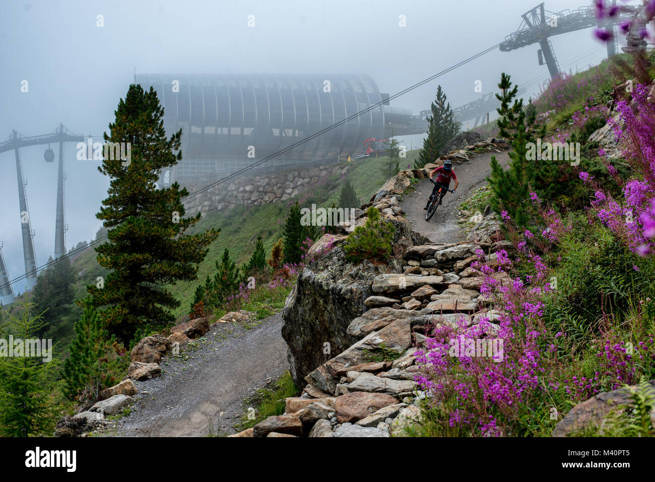 A mountain biker rides a trail in the Austrian alpine resort of Sölden ...